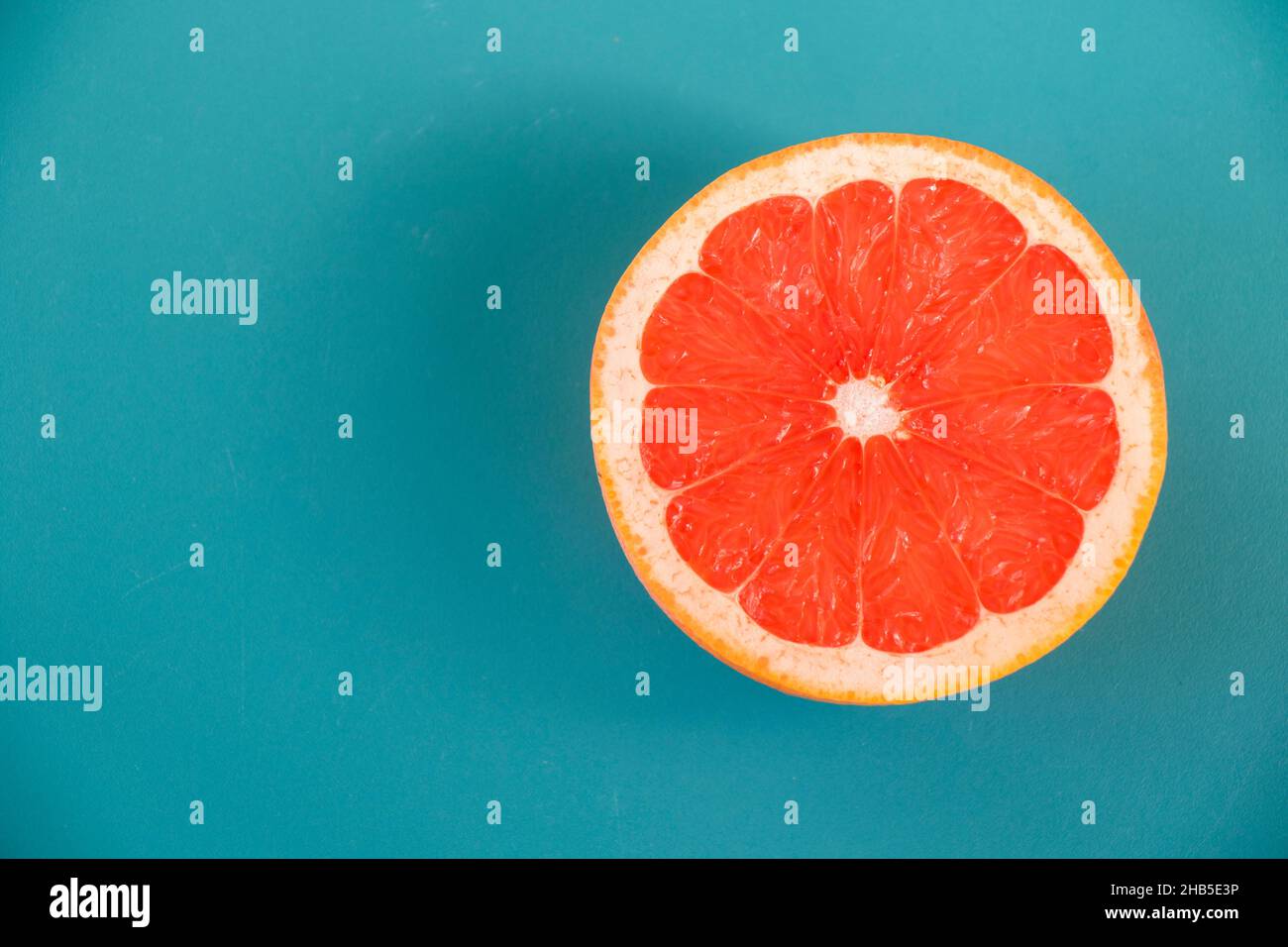 Sliced grapefruit on the blue background, cut grapefruit Stock Photo ...