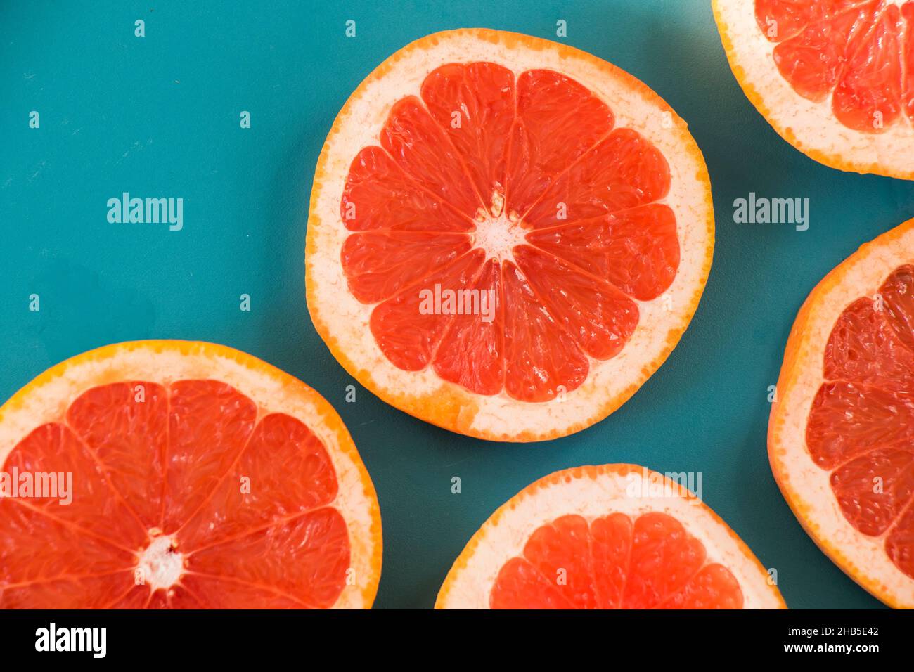 Sliced grapefruit on the blue background, cut grapefruit Stock Photo ...
