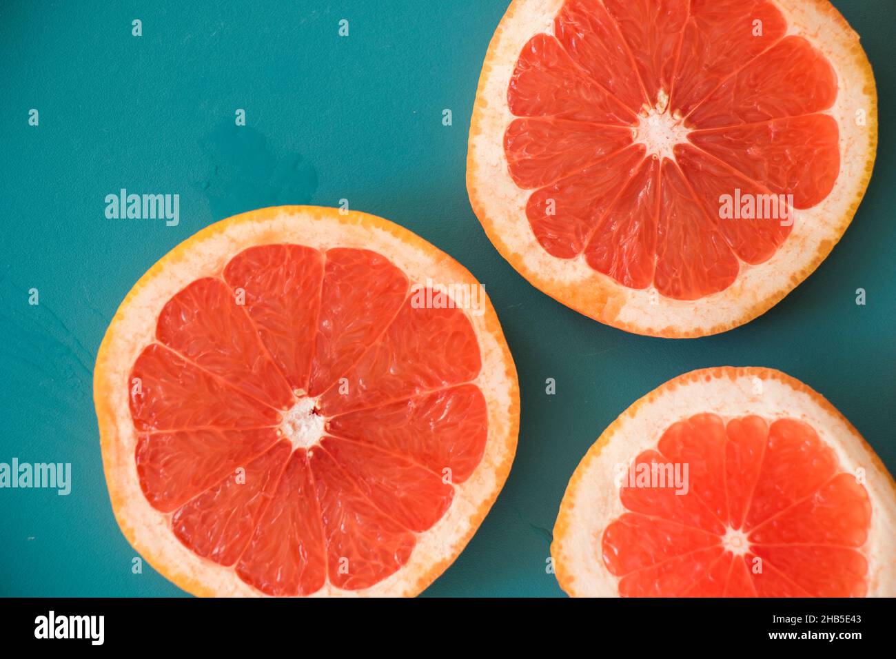 Sliced grapefruit on the blue background, cut grapefruit Stock Photo ...