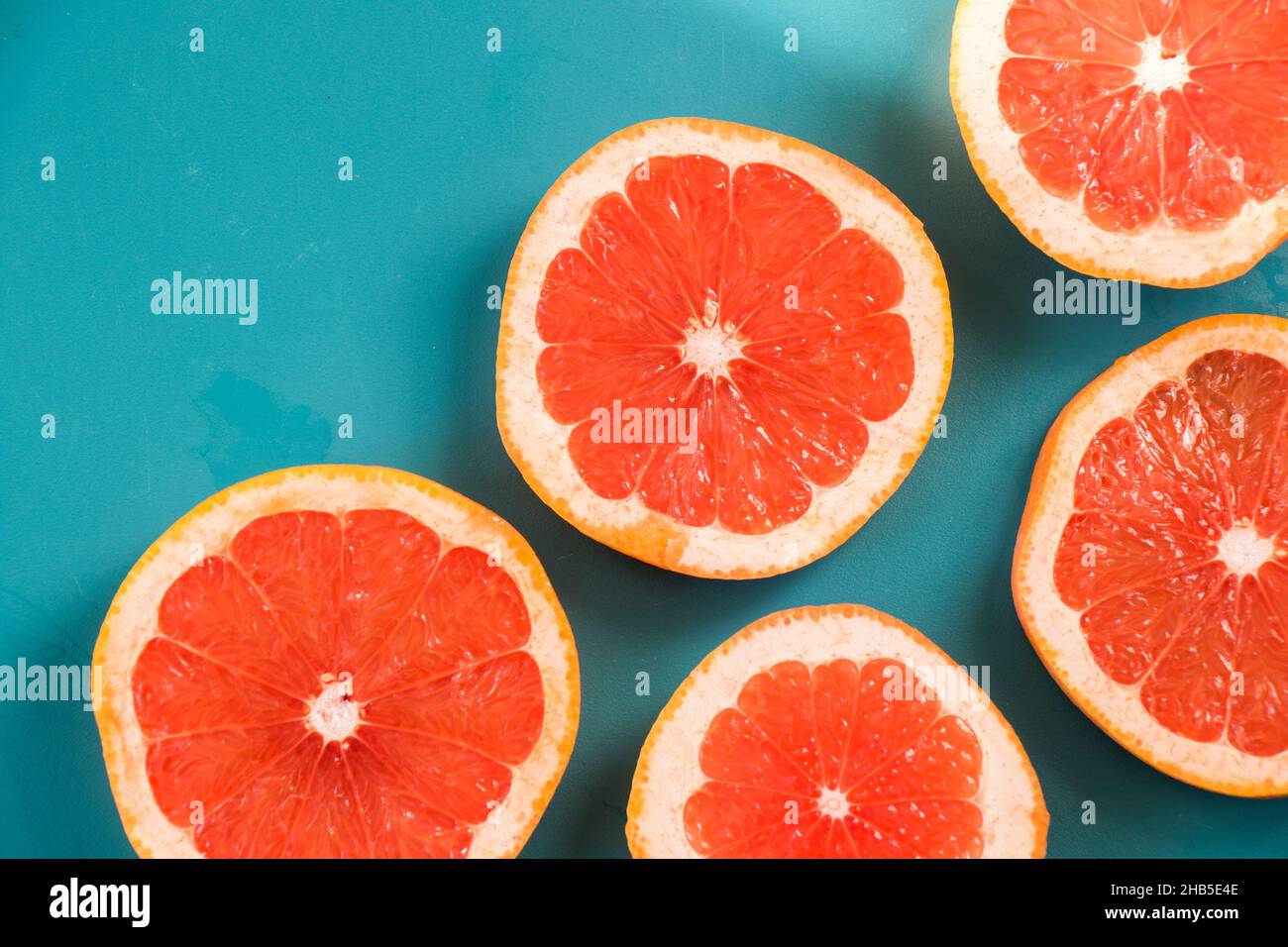 Sliced grapefruit on the blue background, cut grapefruit Stock Photo ...