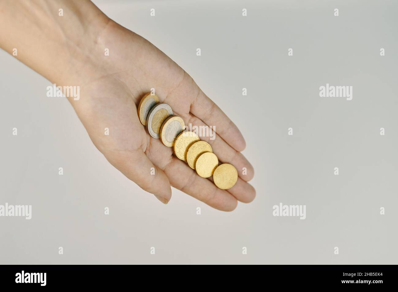Coins in person's hands Stock Photo - Alamy
