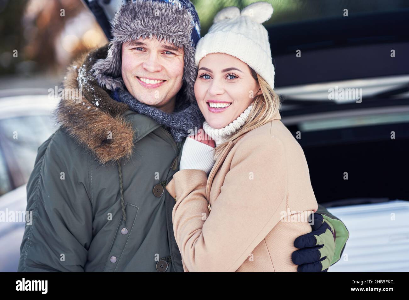 Young family during winter trip car trunk in bacground Stock Photo - Alamy