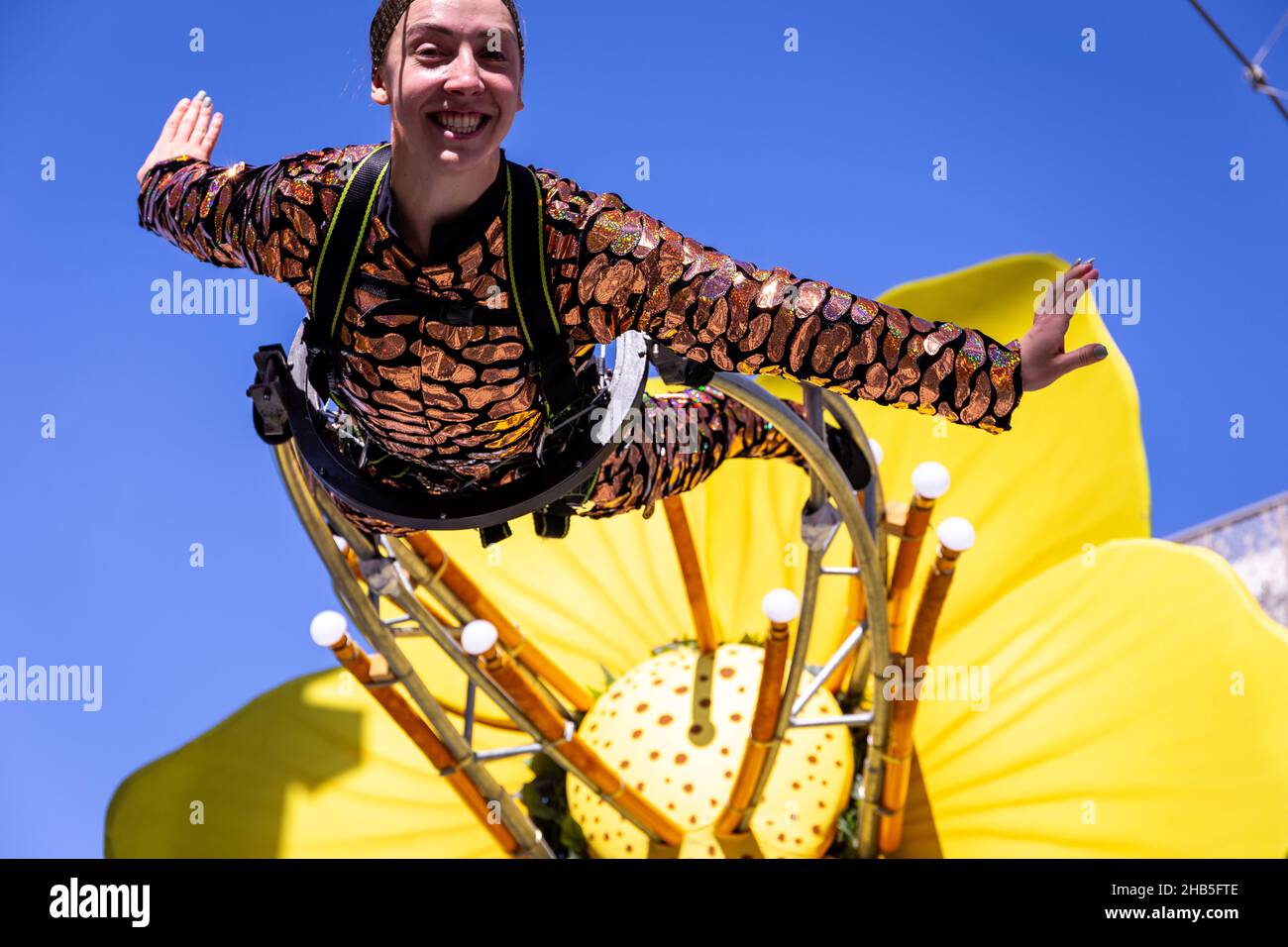 Dubai, UAE, 09.12.2021. Woman performing acrobatics attached to big ...