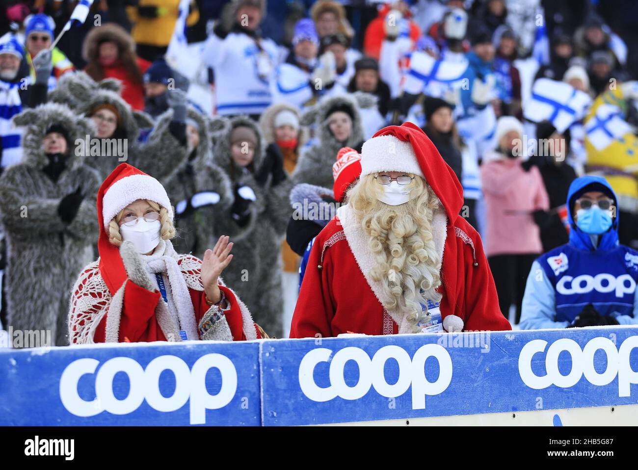 Spectators dressed in Santa Claus outfits celebrate ski jumpers who ...