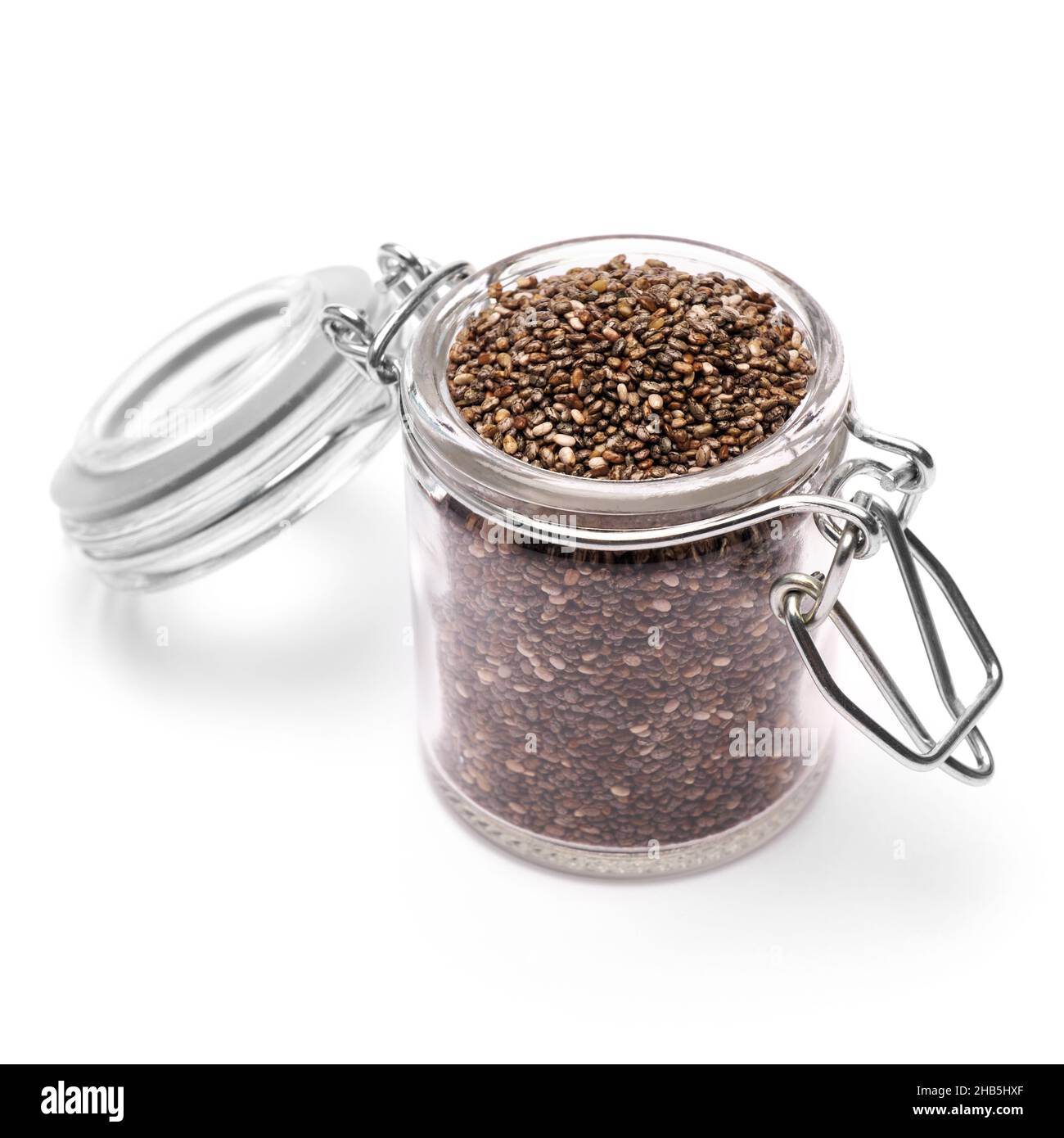 glass can full of organic natural chia seeds close-up isolated on white ...