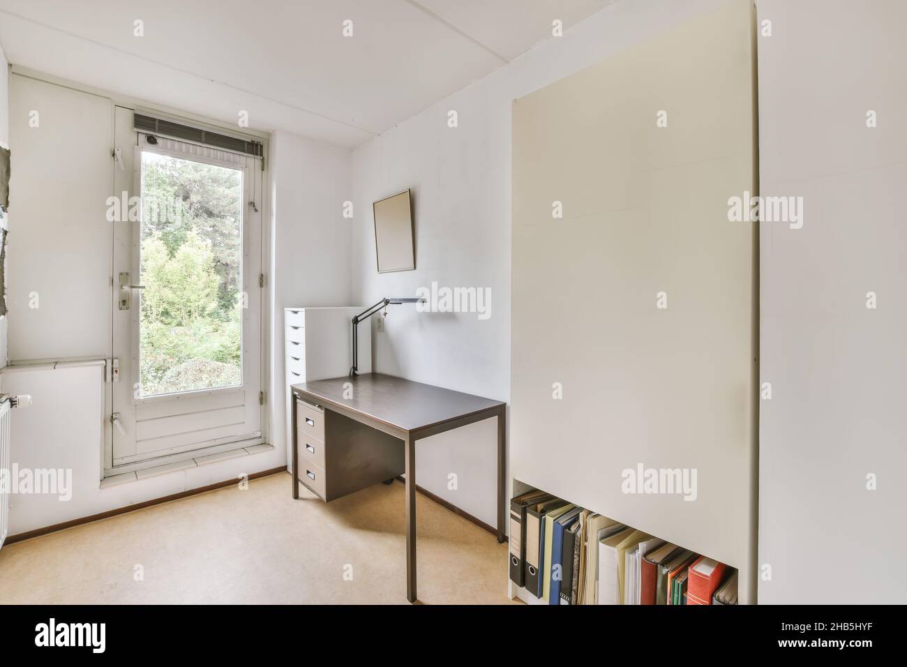 Comfortable work area with a window next to the table Stock Photo - Alamy