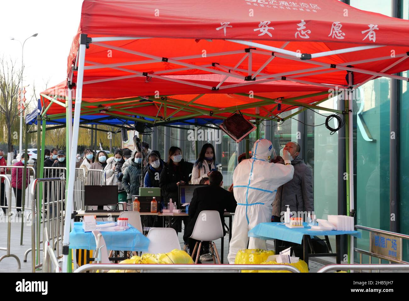 XI'AN, CHINA - DECEMBER 16, 2021 - People line up to take nucleic acid ...