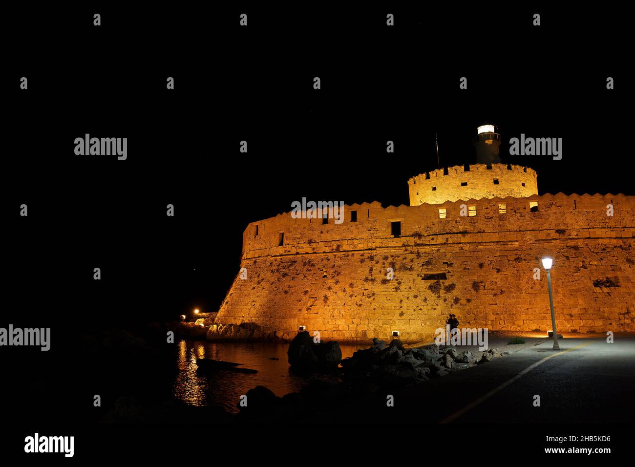 Rhodes harbour by night Stock Photo - Alamy