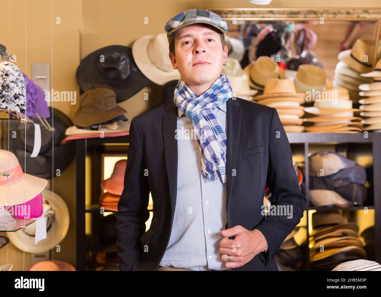 portrait of young male try on newboy cap at the shopping mall Stock ...