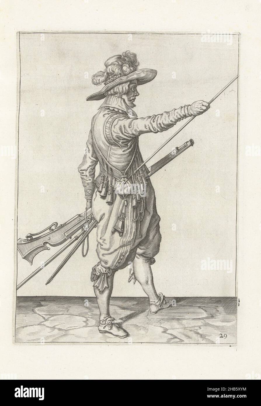 Soldier with a musket sliding his right hand to the end of his ramrod ...
