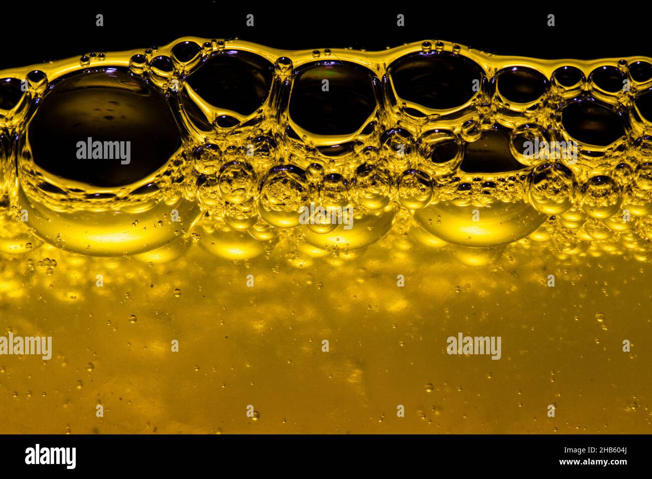 Yellow liquid with bubbles Stock Photo - Alamy