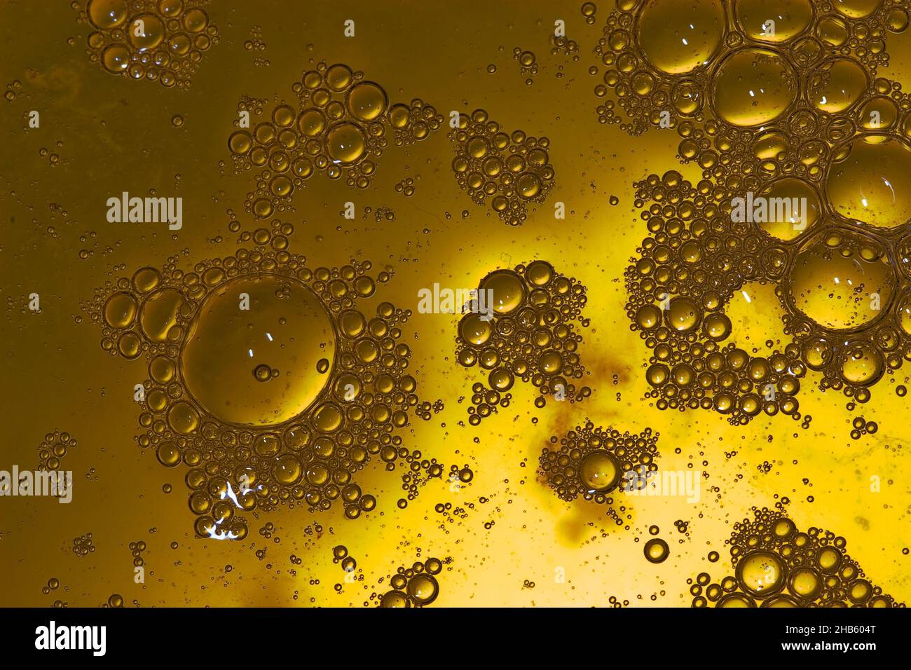 Yellow liquid with bubbles Stock Photo - Alamy
