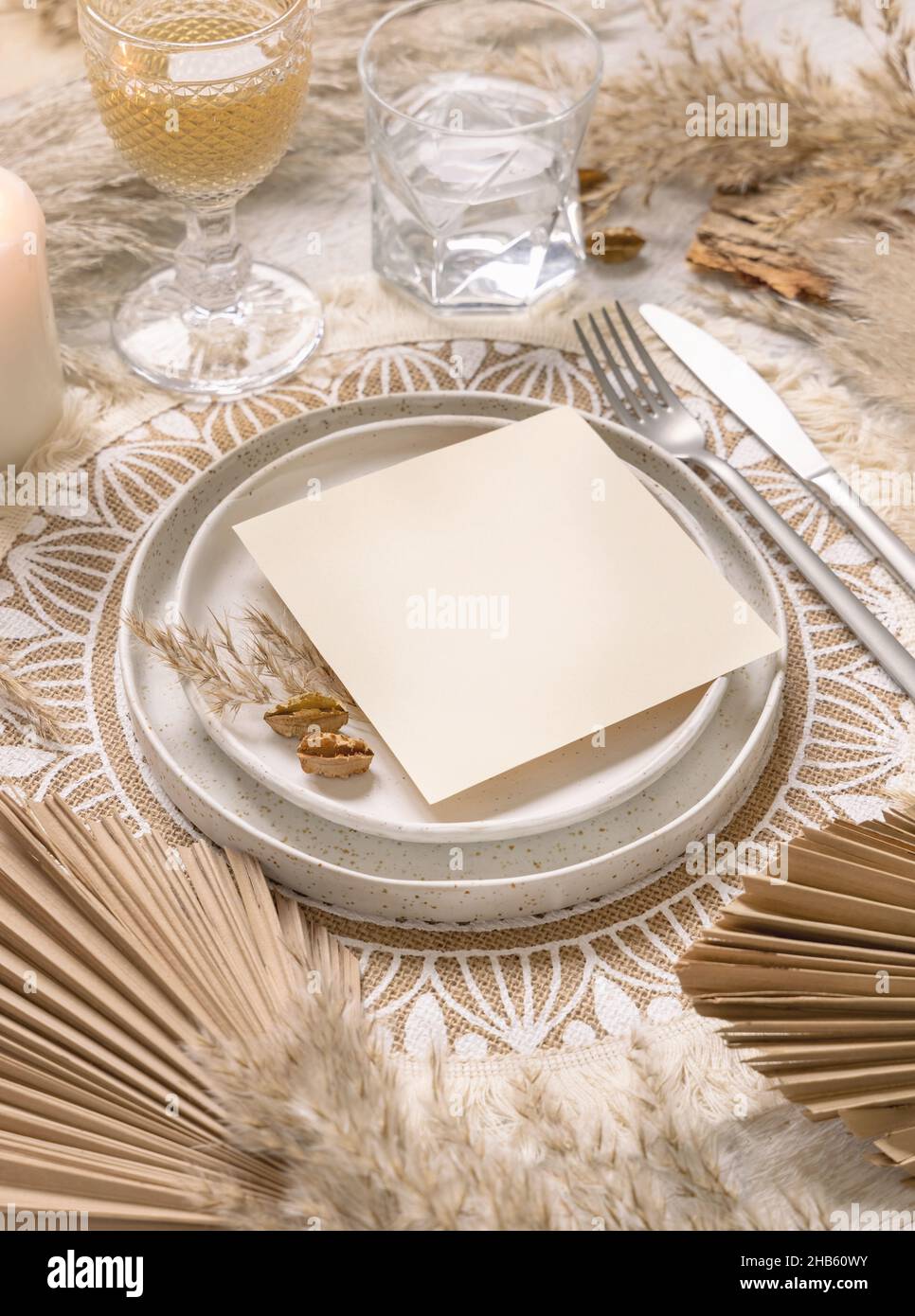 Wedding table place with square blank card on plate on bohemian ...