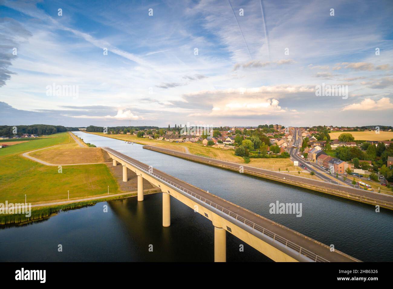 Line of Traditional buildings with cars standing and canal in ...