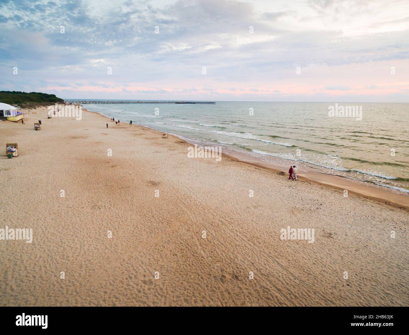 People walking on the beach in summer during sunset. Palanga travel ...