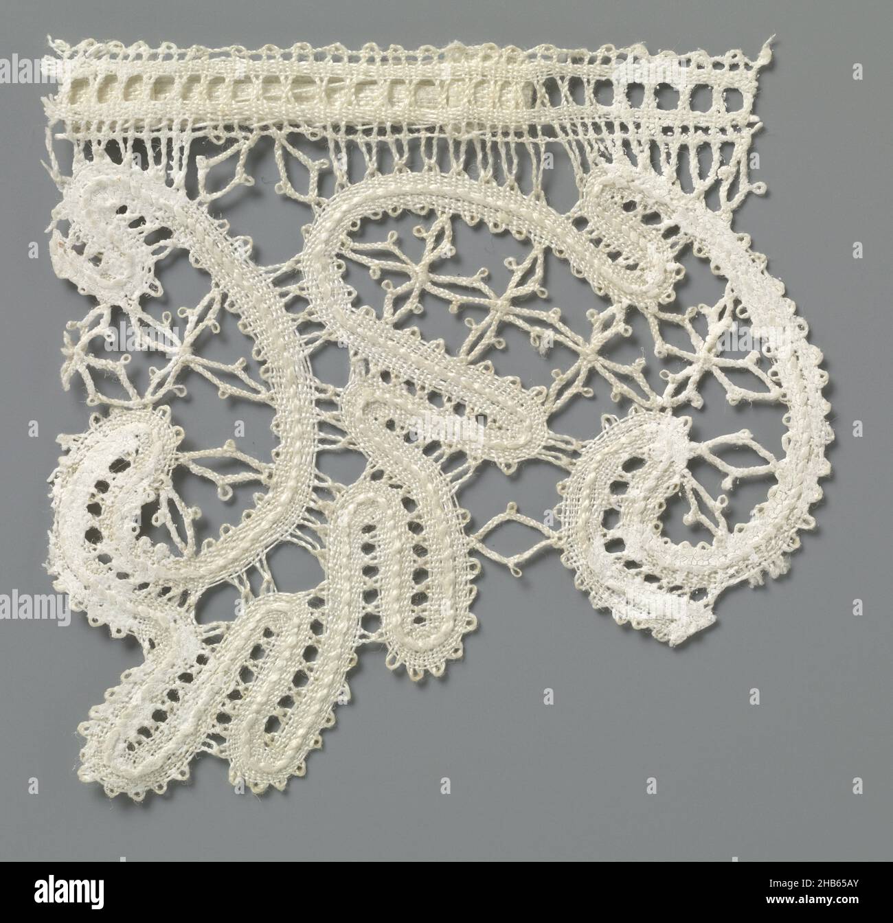 Strip of bobbin lace with swinging ribbon in large curves and narrow ...