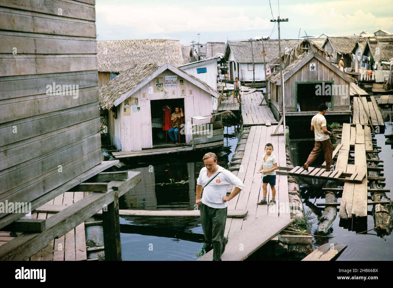 Tourist visiting area of Informal housing wooden shacks built on timber ...