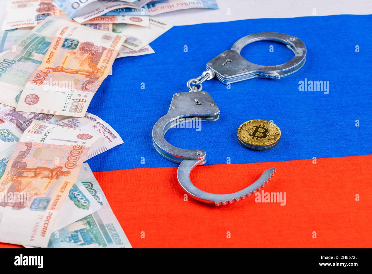 pile of russian paper rubles currency and bitcoin shiner chained with ...