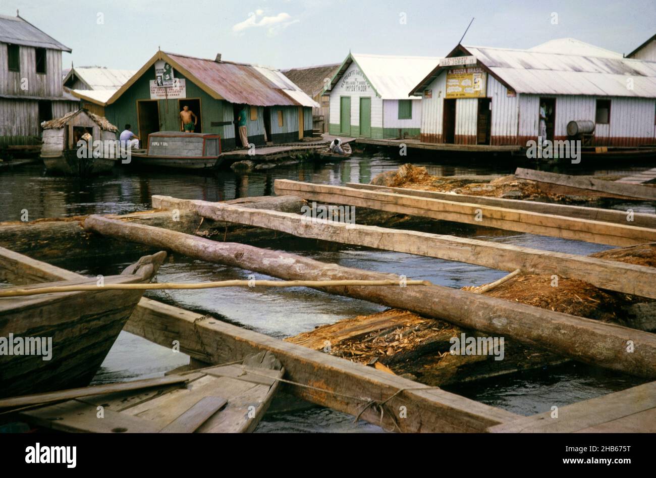 Wooden logs used as building foundations for informal housing area ...