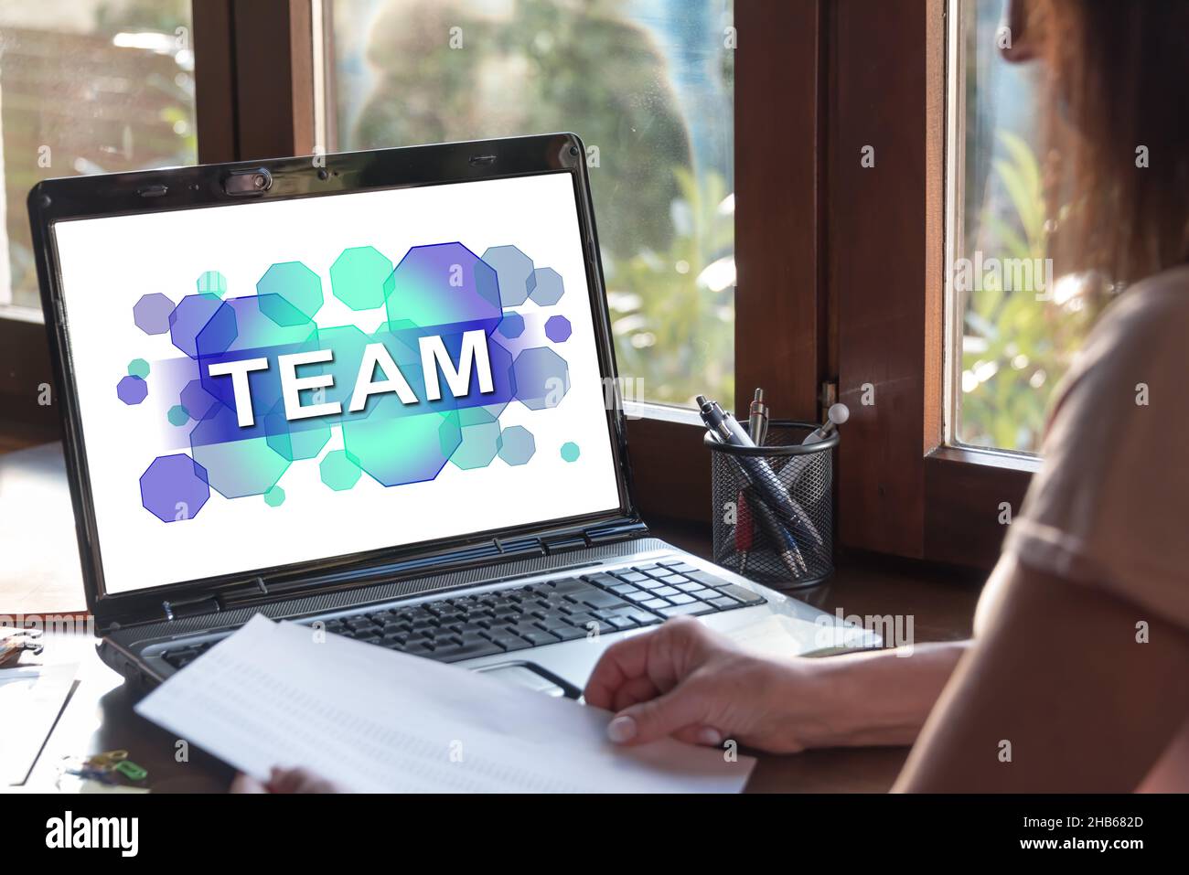 Laptop screen displaying a team concept Stock Photo - Alamy