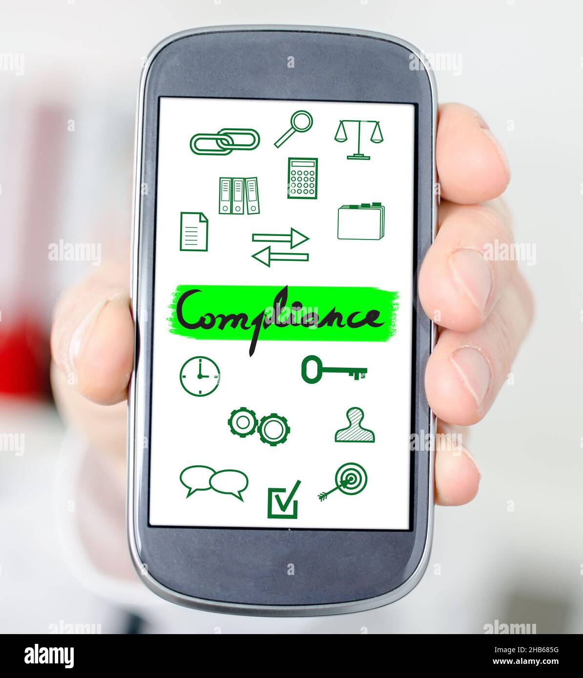 Hand holding a smartphone with compliance concept Stock Photo - Alamy