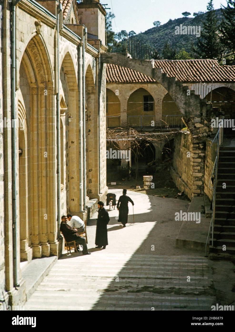 Monks and other people sitting outside church at Panagia Machairas ...