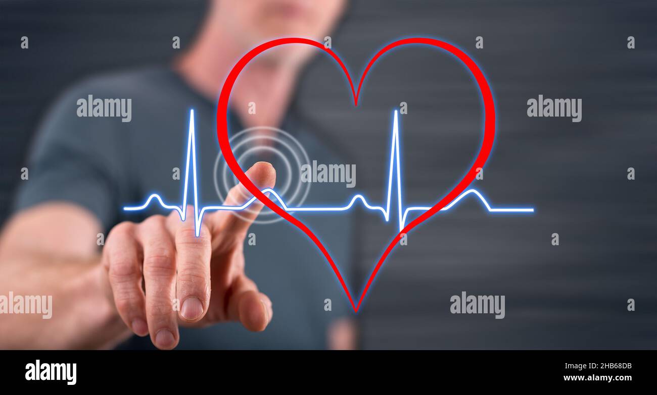 Man touching a heart beats graph on a touch screen with his finger ...