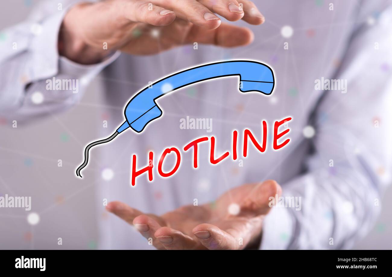 Hotline concept between hands of a man in background Stock Photo - Alamy