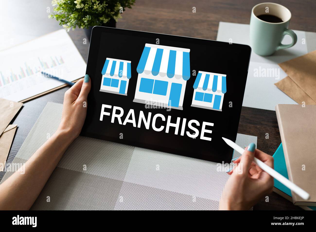 Franchise business model and growth concept on device screen Stock ...