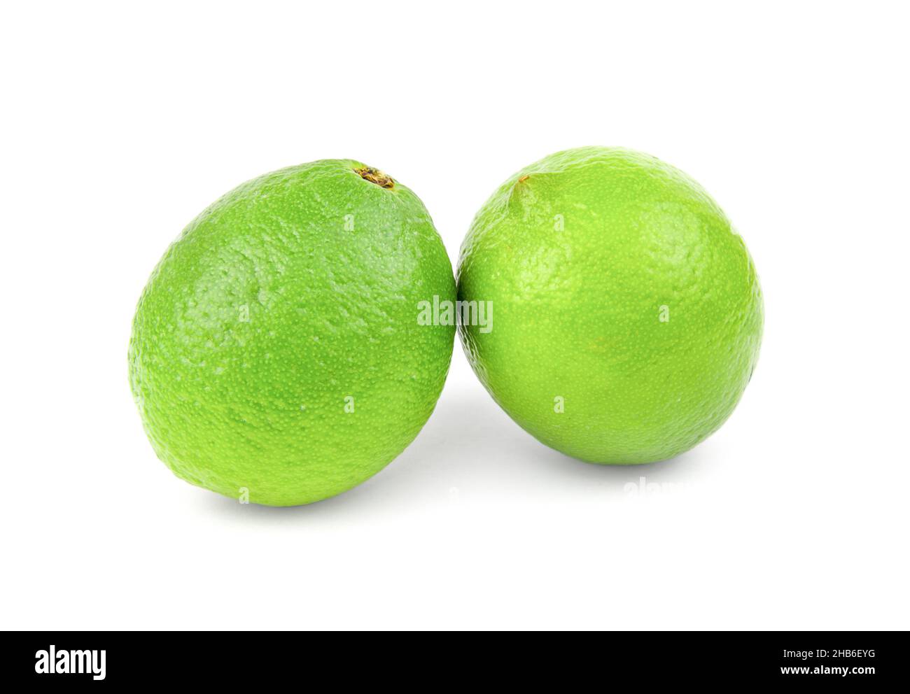 Two juicy lime isolated on white background cutout Stock Photo - Alamy