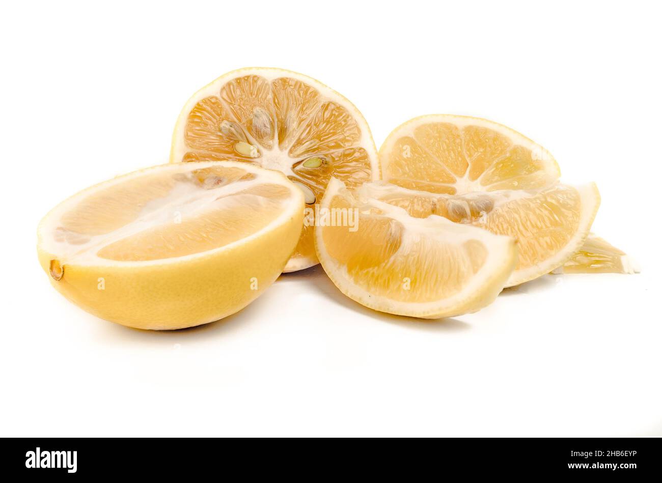Fresh cut lemon halves and slices on white background Stock Photo - Alamy
