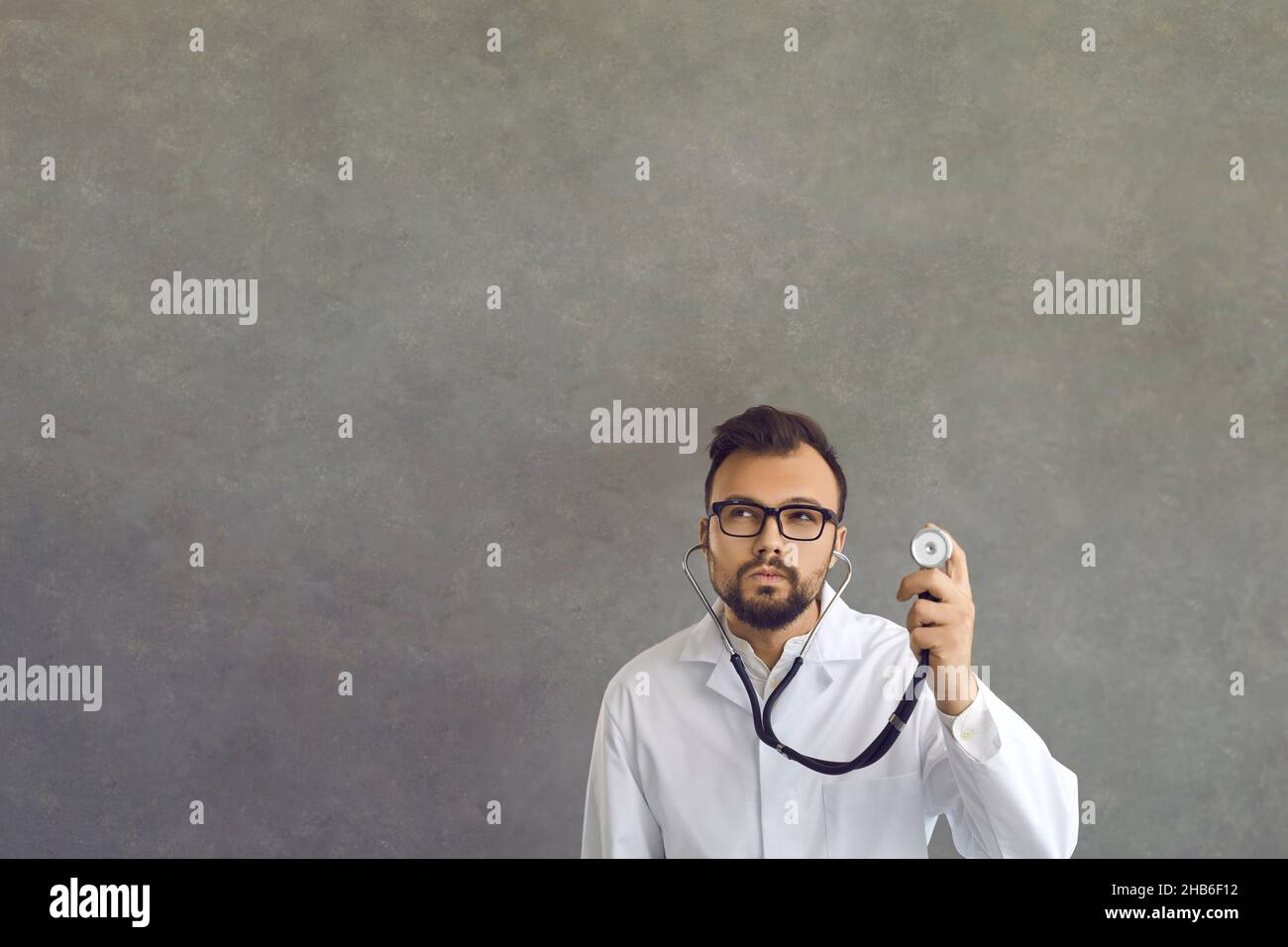 Doctor physician with stethoscope practicing medicine studio portrait ...