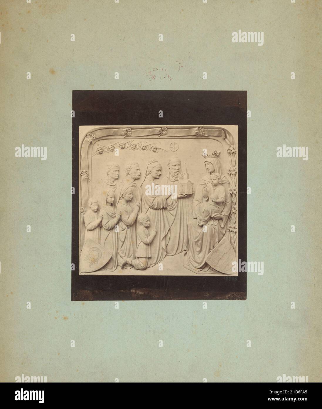 Relief of a family offering a model of a church to Mary and Christ ...