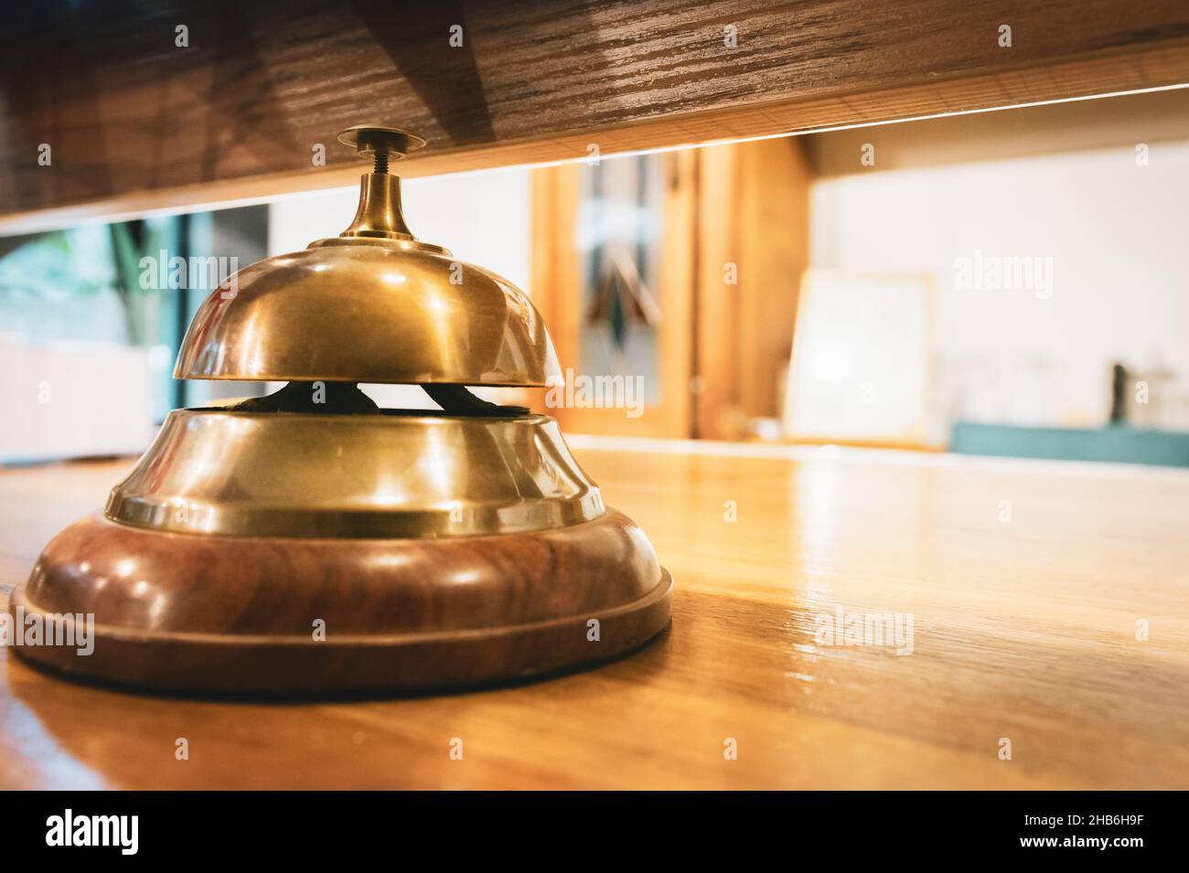Giant ring bell on the wooden front desk with nobody around Stock Photo ...