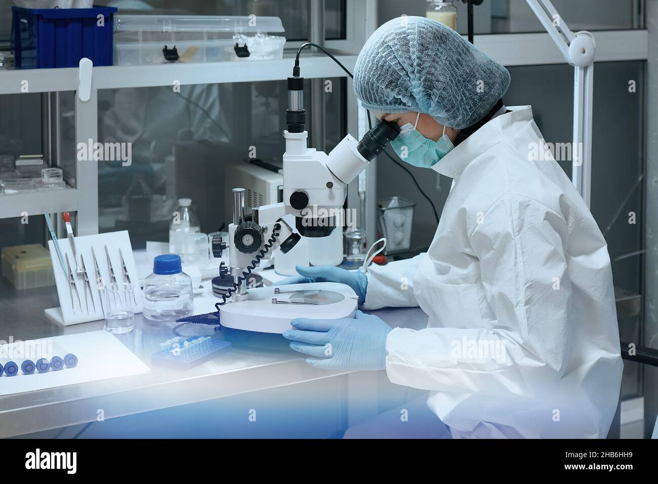 Female scientist looking through a microscope in laboratory Stock Photo ...