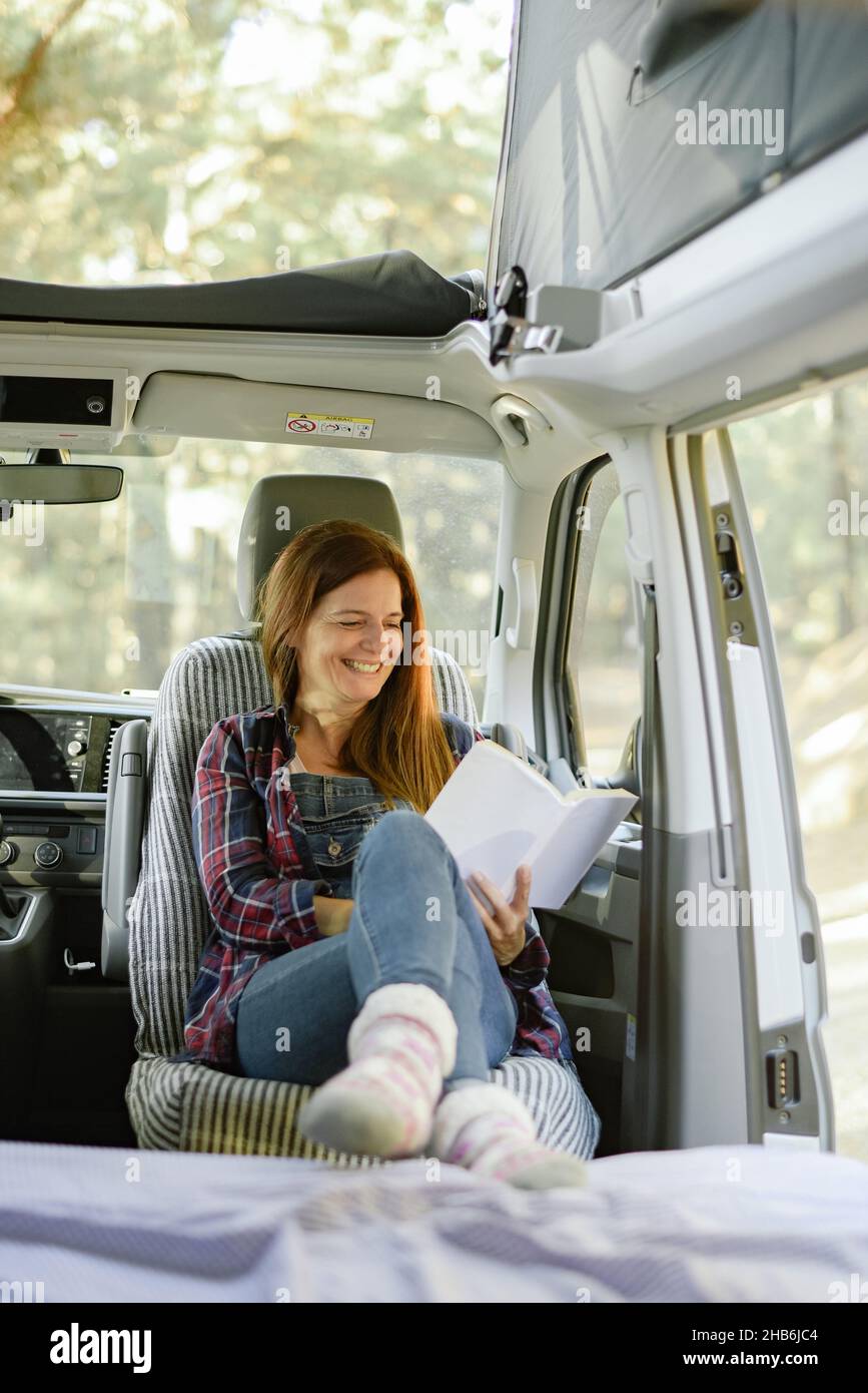 Woman in parked van reading book hi-res stock photography and images ...