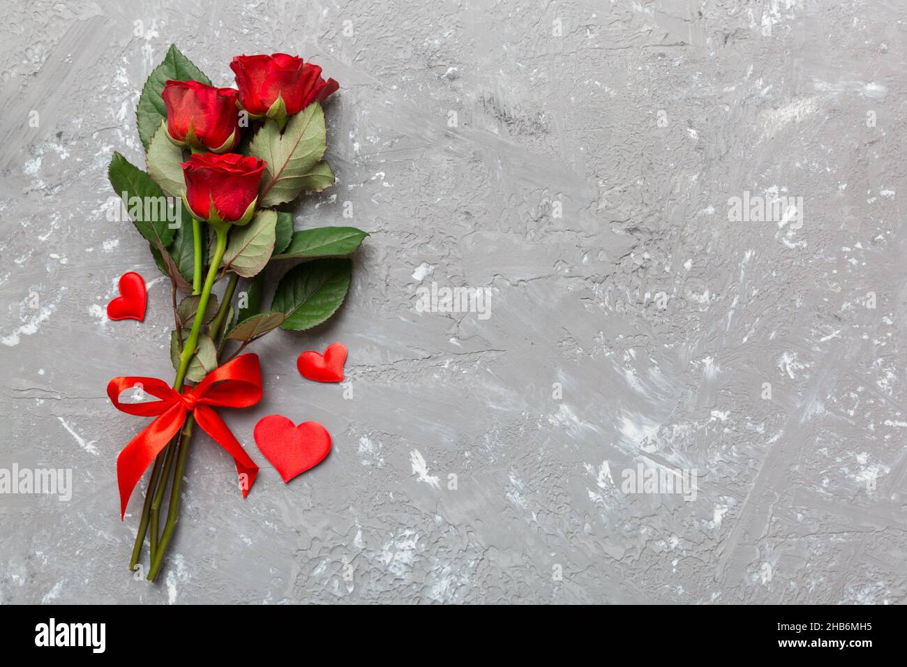 Valentine day composition with rose flower and red heart on table. Top view, flat lay, copy ...