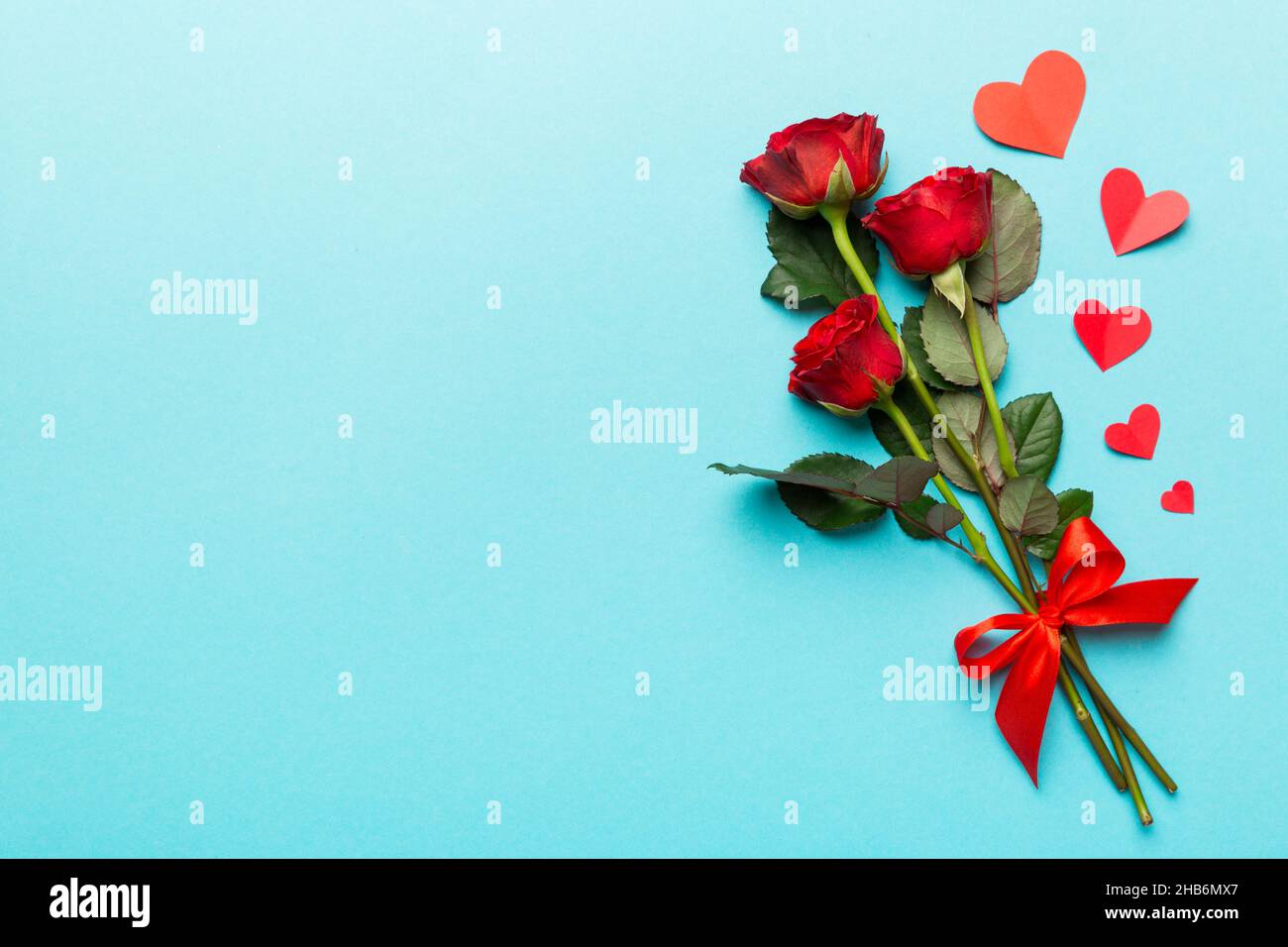 Valentine day composition with rose flower and red heart on table. Top view, flat lay, copy ...