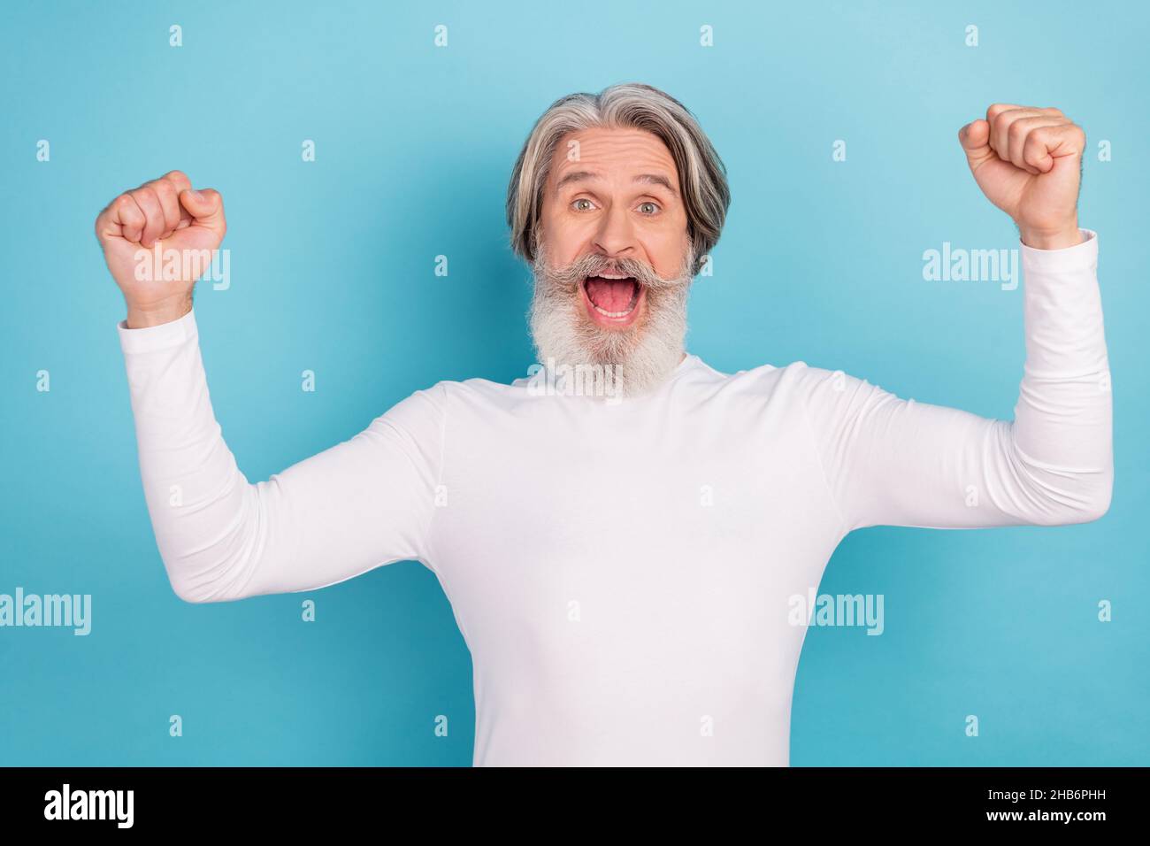 Portrait of attractive cheerful lucky grey-haired man rejoicing having ...
