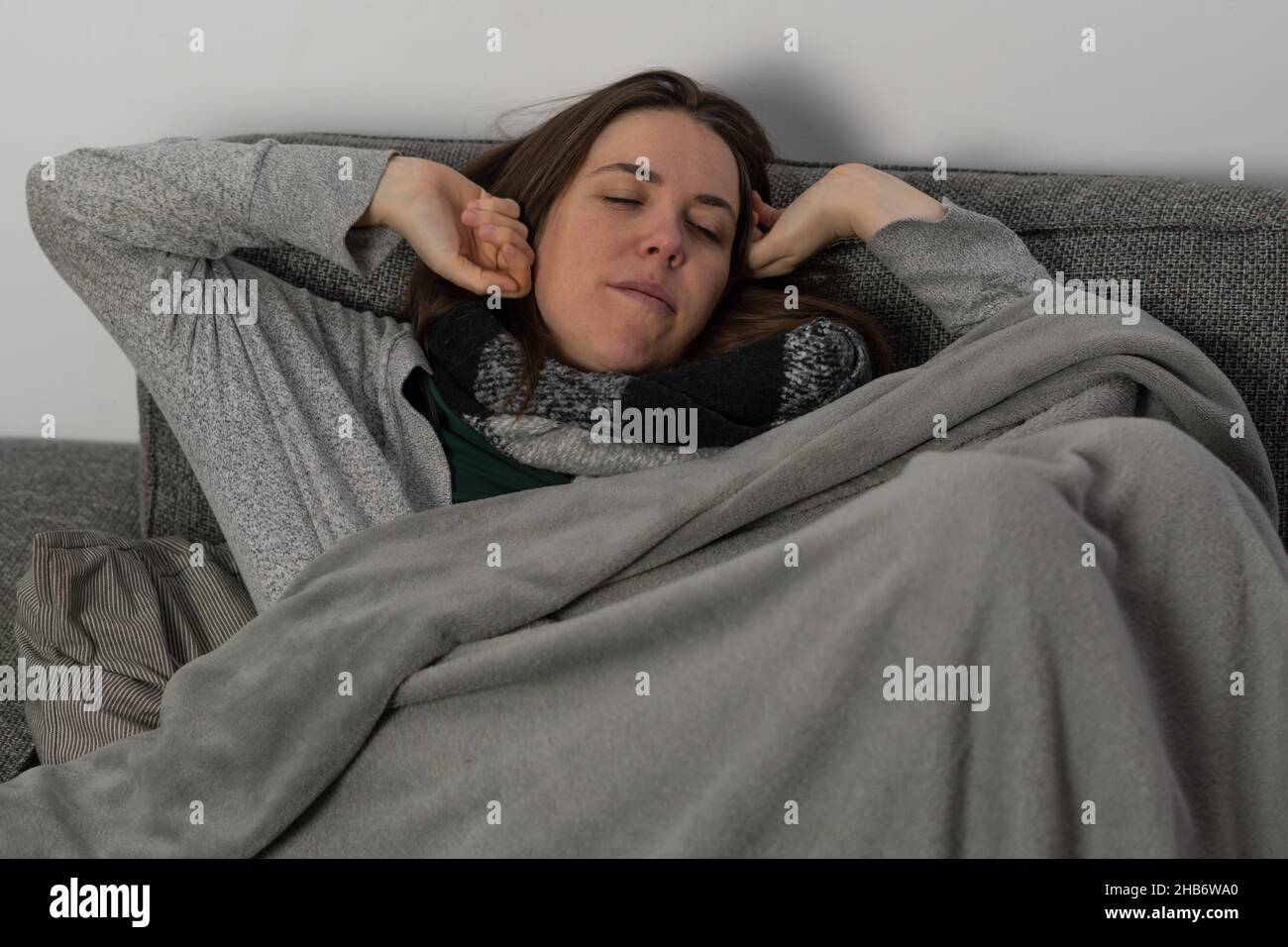 sick young girl lying on the sofa at home Stock Photo - Alamy