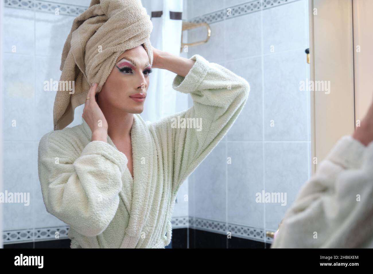 Drag queen person getting ready after shower in front of the bathroom ...