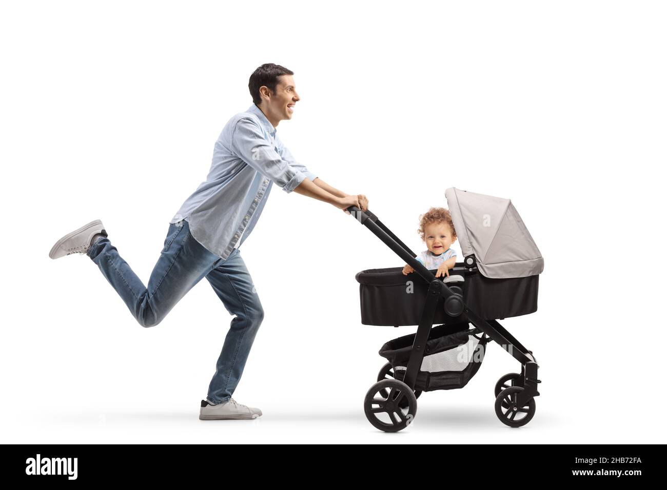 Full length profile shot of a cheerful father running and pushing a ...