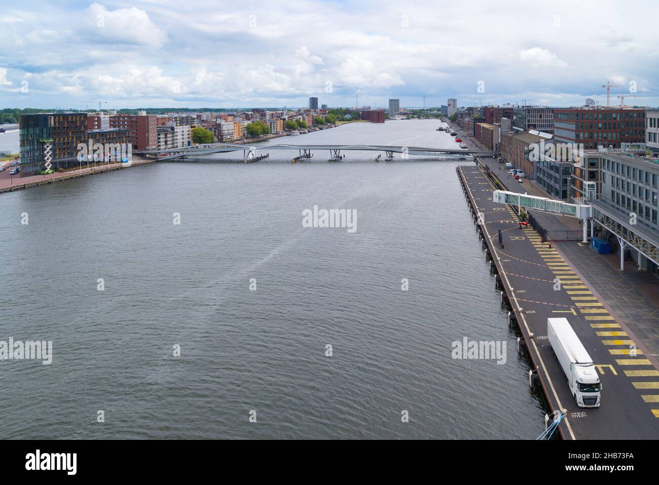 View over the Amsterdam IJ harbor and the Jan Schaefer bridge in front ...