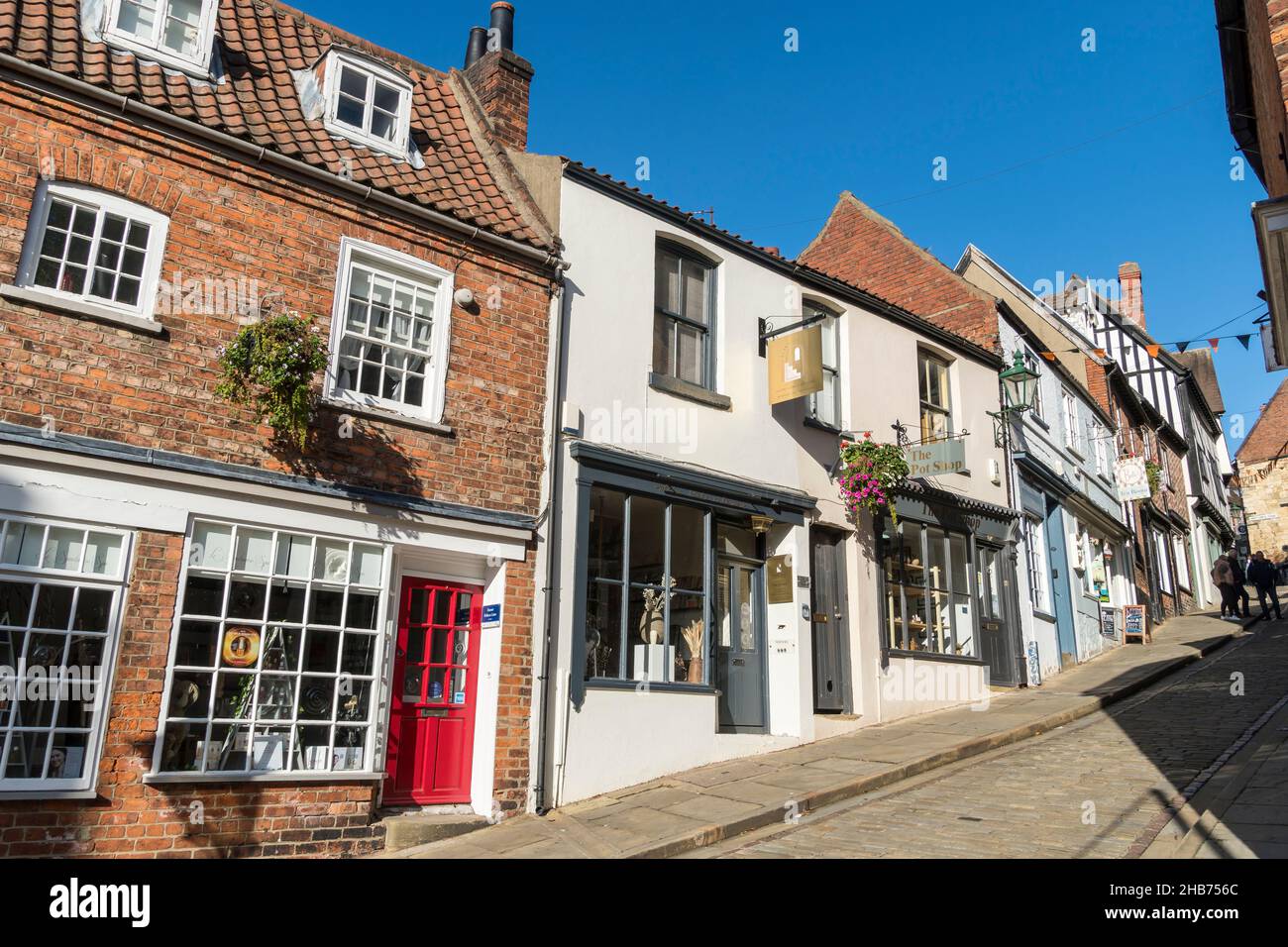 Shops on west side of lower Steep Hill Lincoln city 2021 Stock Photo ...