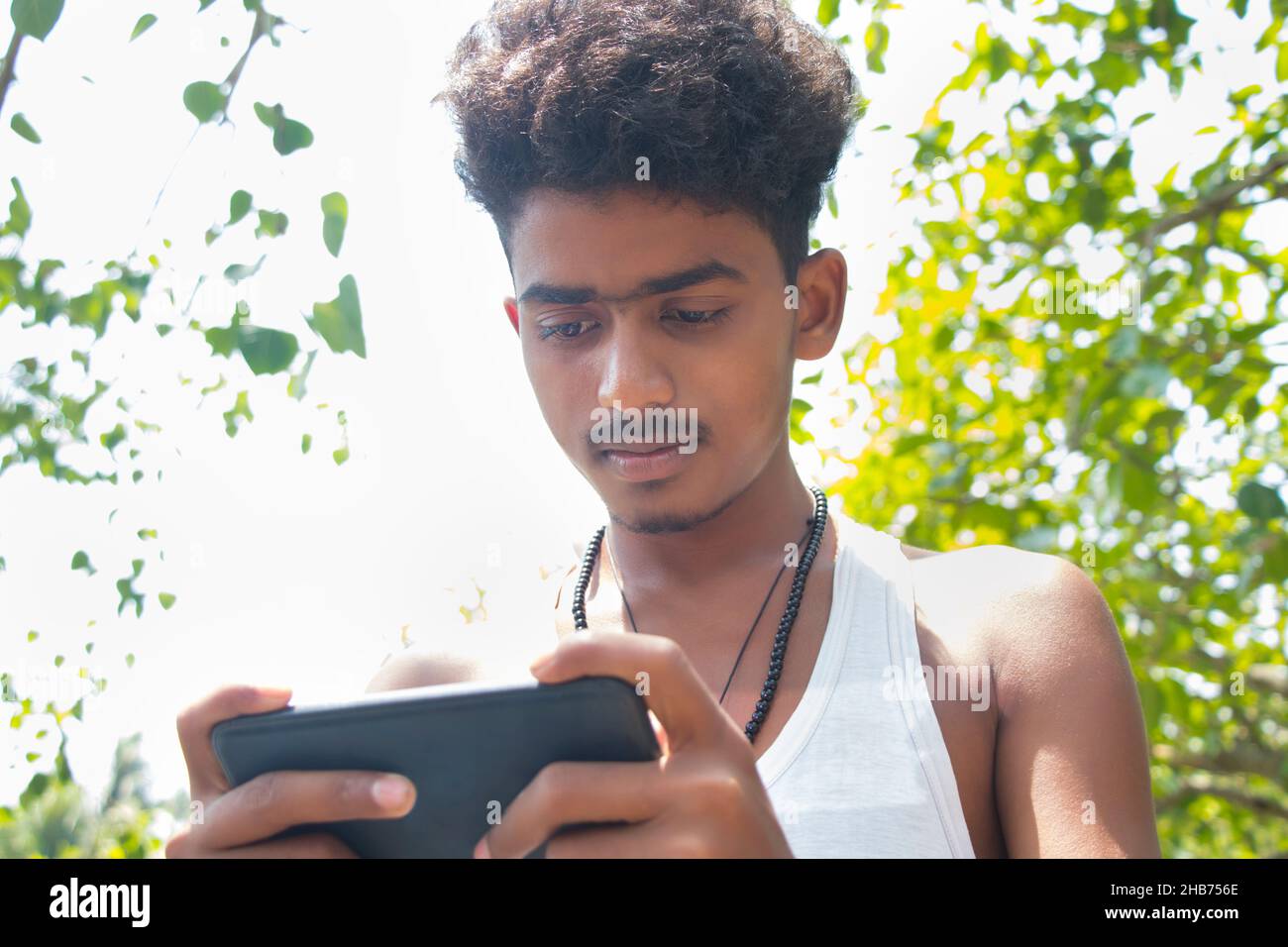 Rural boy using mobile phone in outdoor Stock Photo - Alamy