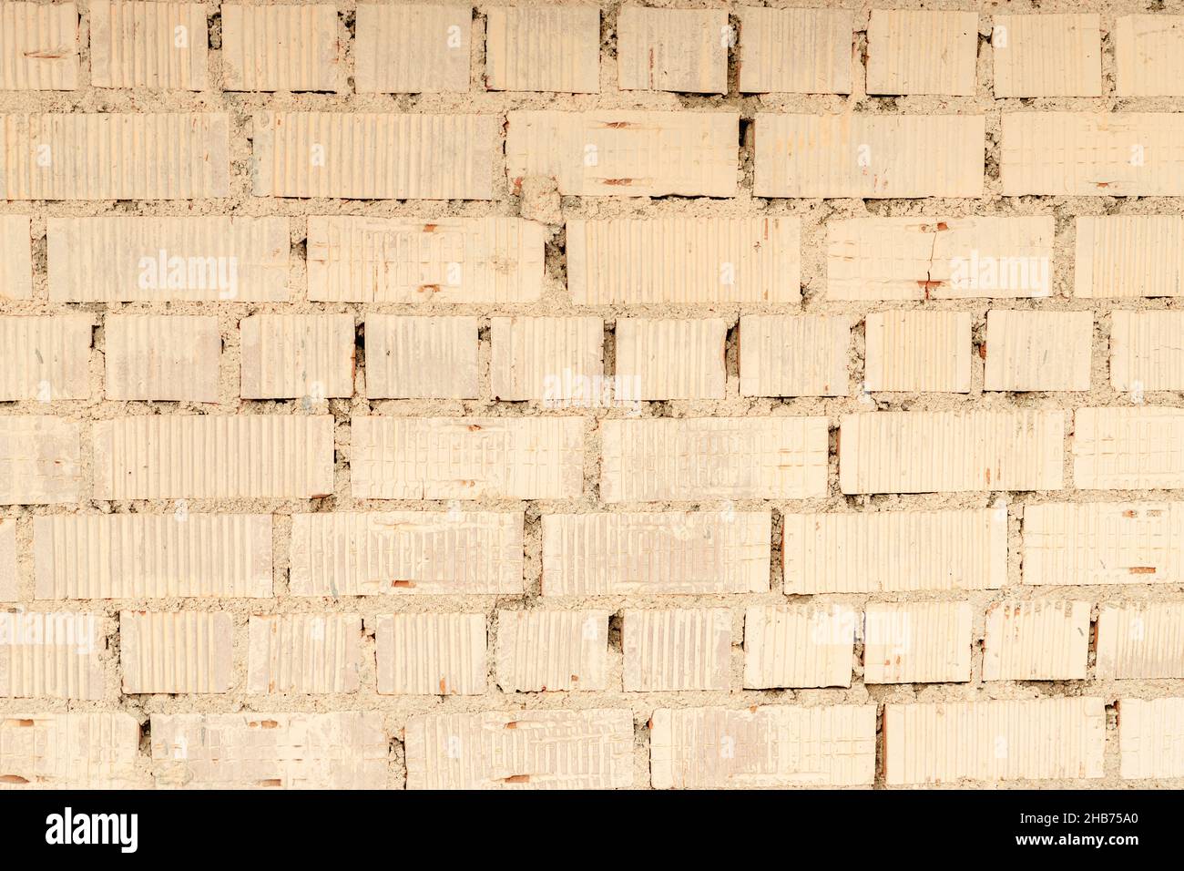 Wall of bricks painted with a pale peach paint Texture of masonry ...
