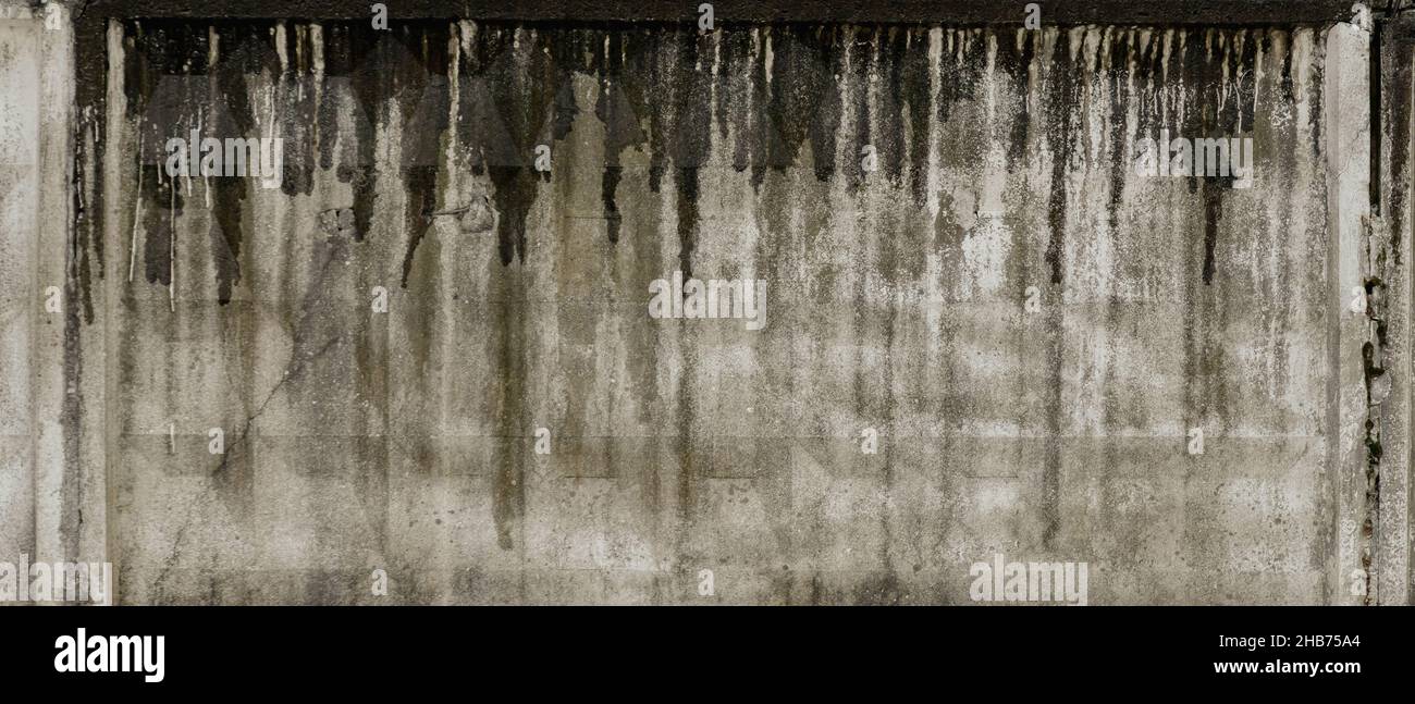 Texture of grey concrete wall with dark water and oil marks running ...