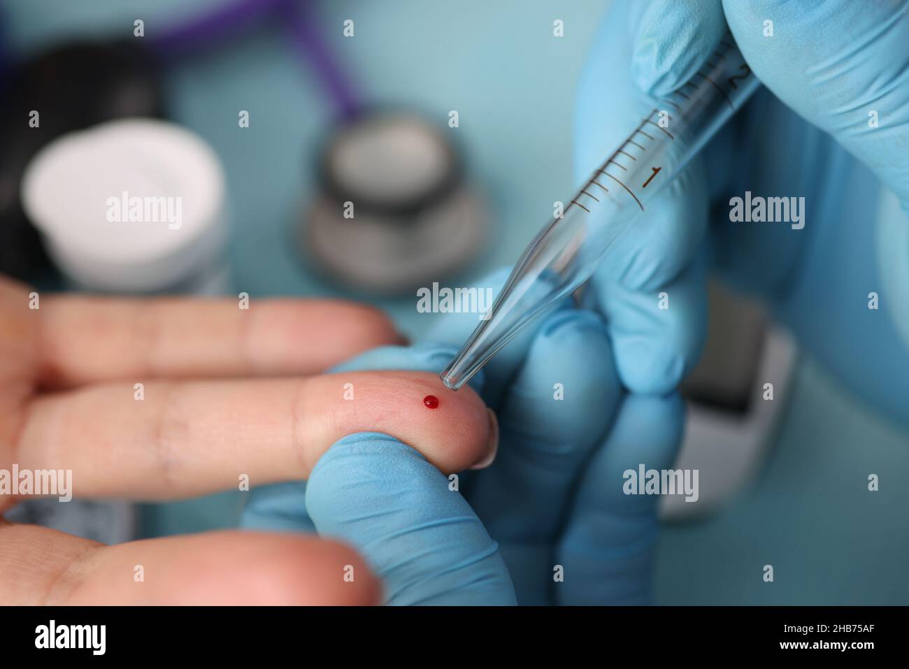 Doctor take blood of client finger with glass tube, usual procedure at ...