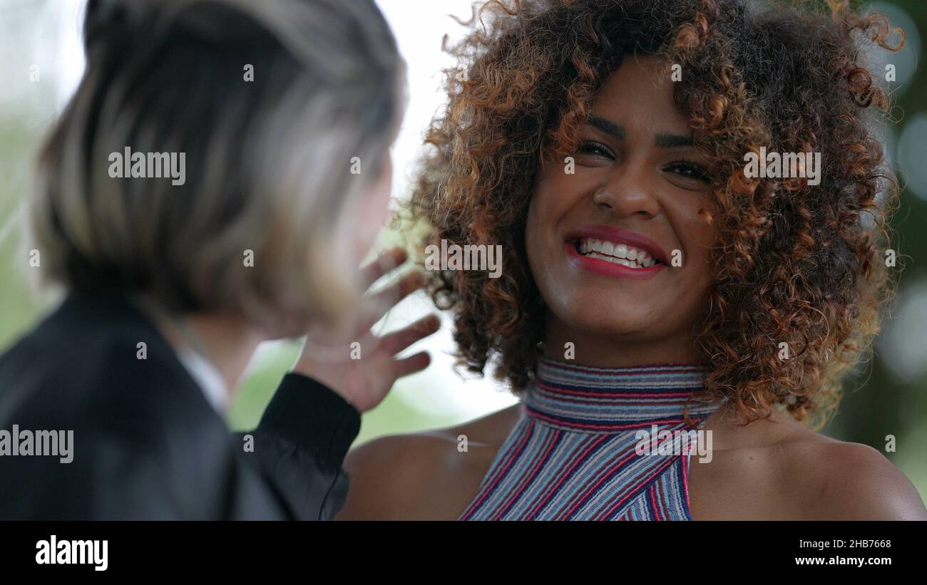 Two diverse friends talking outside at park. people conversation Stock ...