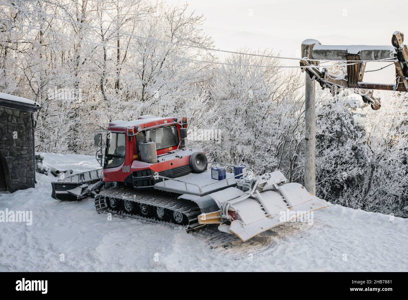 Red snowcat parked under ski lift in ski resort Stock Photo - Alamy